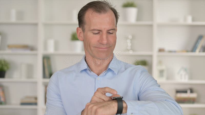 Portrait of Middle Aged Businessman Using Smart Watch Stock Image ...