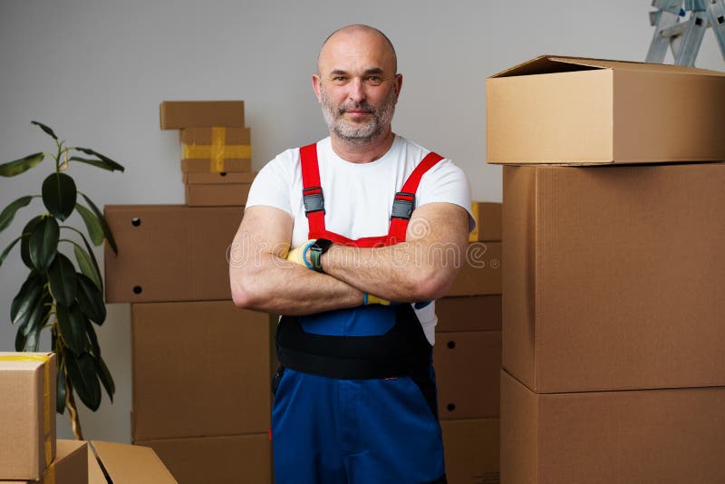 Portrait of a Middle-aged Man Mover in Uniform Standing Against Stacked ...