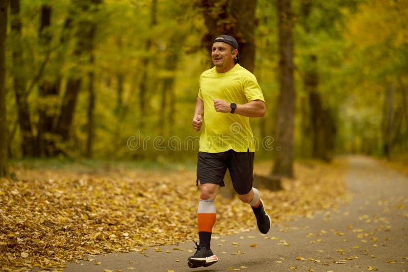 Portrait of a Middle-aged Man Running in the Park Stock Photo - Image ...