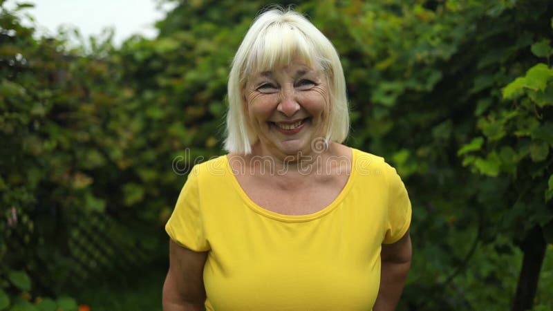 Portrait Of An Attractive Mature Woman Posing At The Park Stock Footage