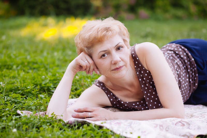 Portrait of Middle Aged Woman Smiling in the Park Stock Image - Image ... Portrait of Middle Aged Woman Smiling in the Park Stock Image - Image ...