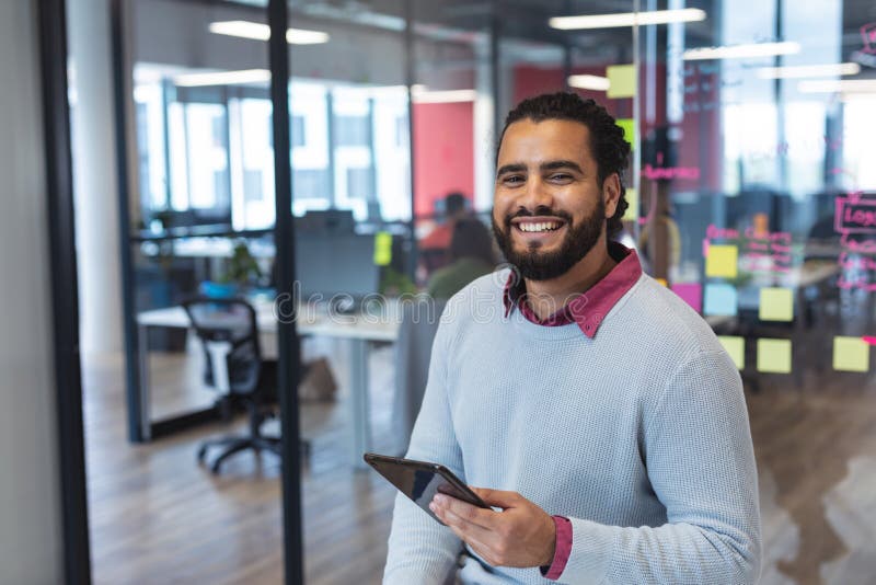 Portrait of Mixed Race Male Creative Worker Using Tablet Computer and ...