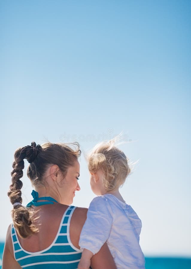 Portrait of Mother and Baby on Beach. Rear View Stock Image - Image of ...