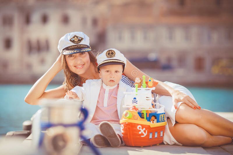 Portrait Of A Mother With Her Son Playing On The Jetty By The Sea In The City Still Life Photo
