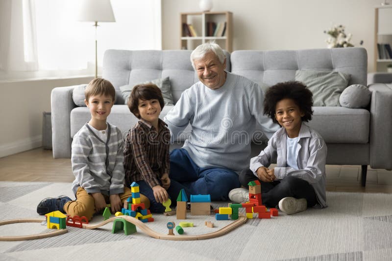 Portrait of Multigenerational Family Sit on Floor Staring at Camera ...