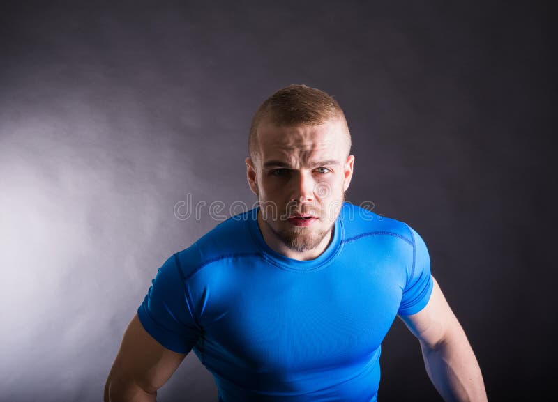Portrait of a Muscular Aggressive Young Man Standing in Studio on Black ...
