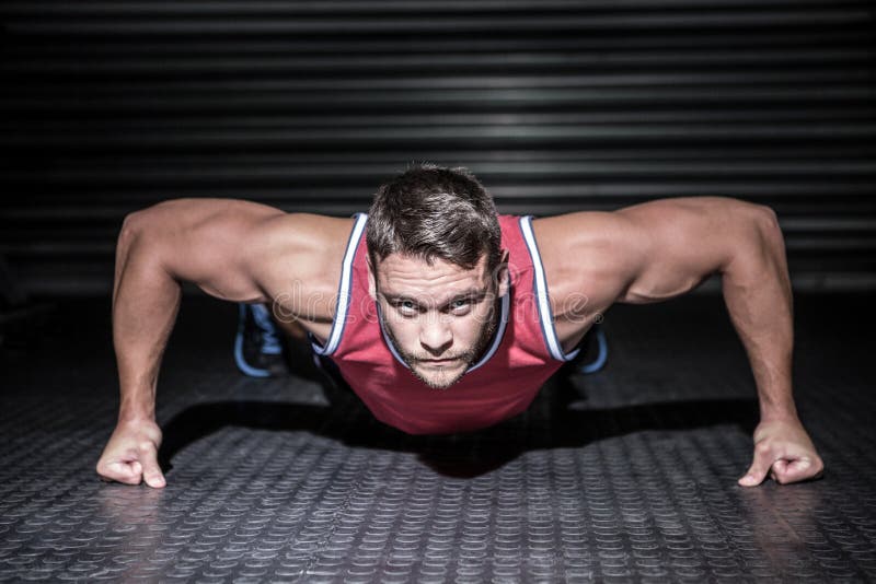 Portrait of a Young Handsome Sportsman Doing Push Ups Exercise with One ...