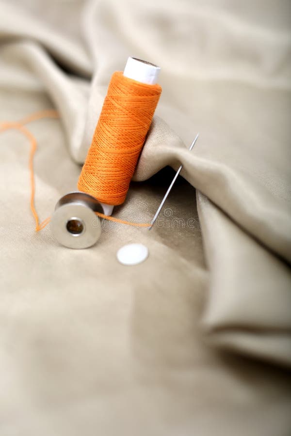 Portrait of Needle Attached in Cloth with Orange Sewing Thread and ...