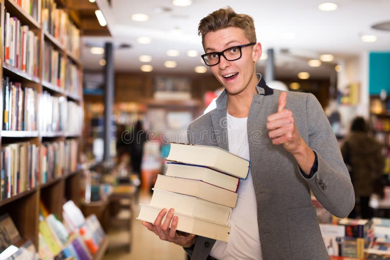 Portrait of Nice Guy Standing with Pile of Books Stock Photo - Image of ...