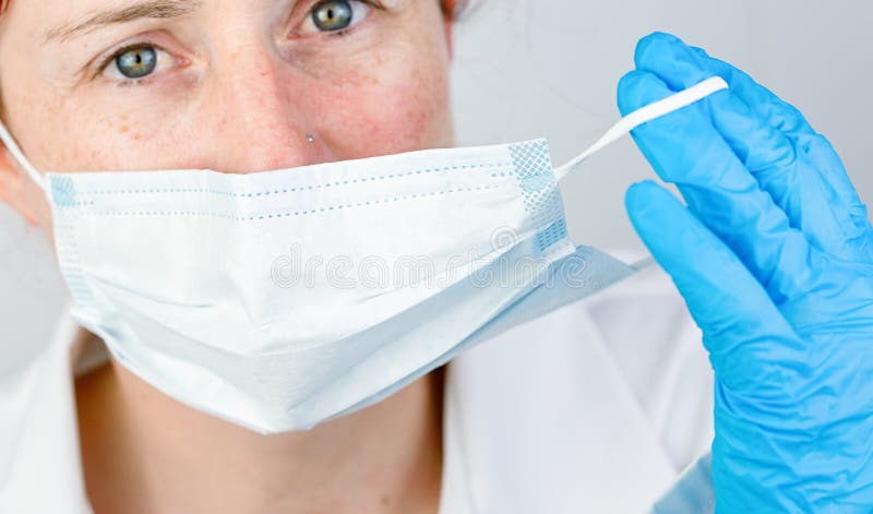 Portrait of a Nurse Adjusting Her Protective Surgical Mask Stock Photo ...