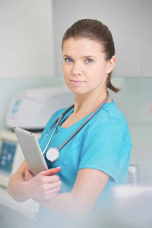 Portrait of Nurse with Digital Tablet Standing at Clinic Stock Image ...