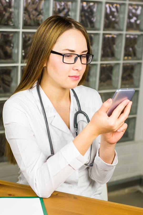 Portrait of Nurse in Office Using Smartphone Stock Image - Image of ...