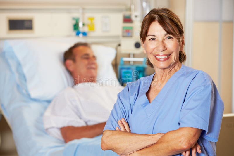 Portrait of Nurse with Patient in Background Stock Photo - Image of ...