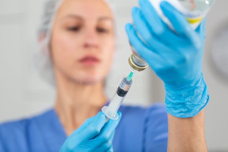 Portrait of a Nurse with Syringe Preparing for Vaccination Stock Image ...
