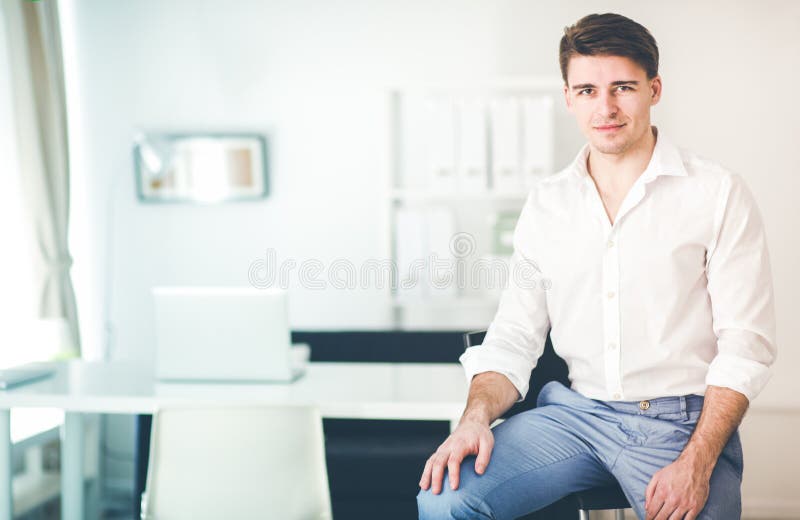 Portrait of Office Worker Man Sitting at Office Desk Using Laptop ...