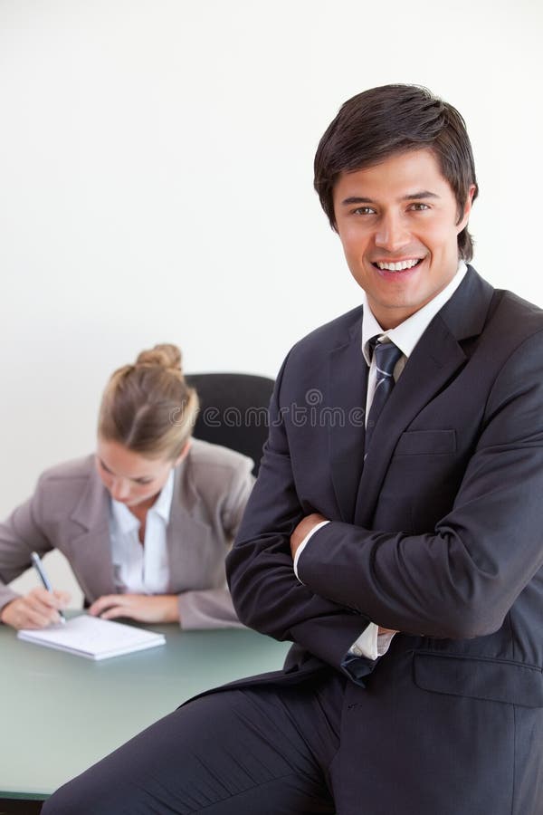 Portrait of an Office Worker Posing while His Colleague is Working ...