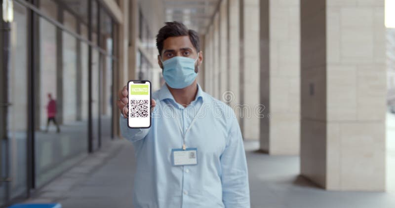 Portrait of Office Worker in Safety Mask Showing Smartphone Screen with ...