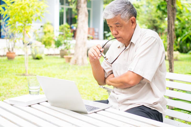 Portrait of Old Elderly Asian Man Using a Computer Laptop in the ...