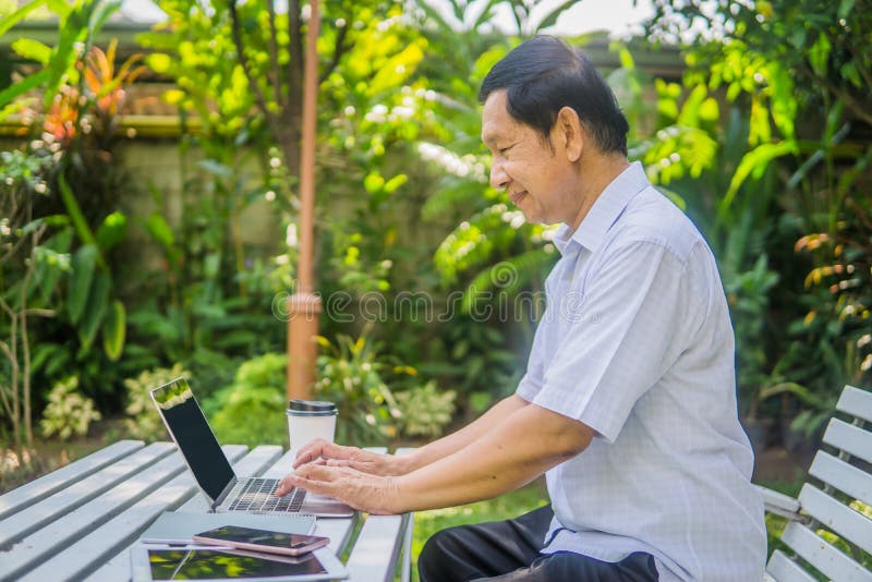Portrait of Old Man Sitting on Couch and Using Laptop Stock Photo ...