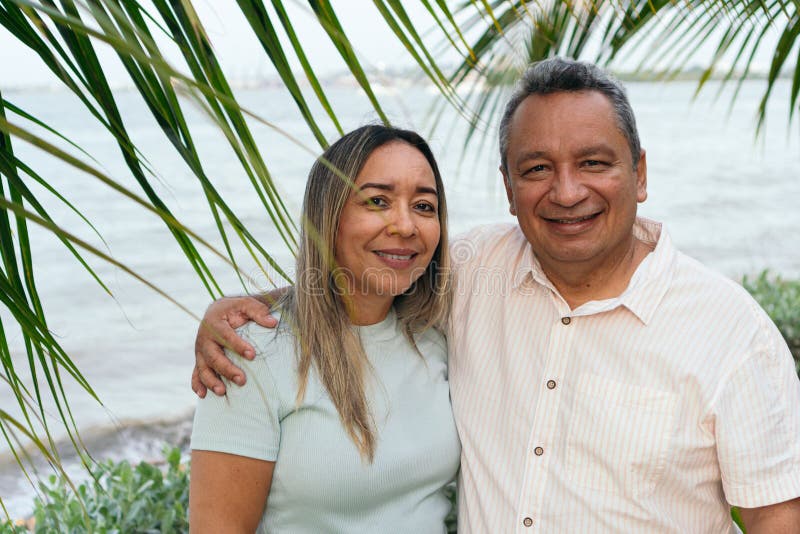 Sad Latino Couple with Medical Mask at Cemetery. Mother Mourning the ...
