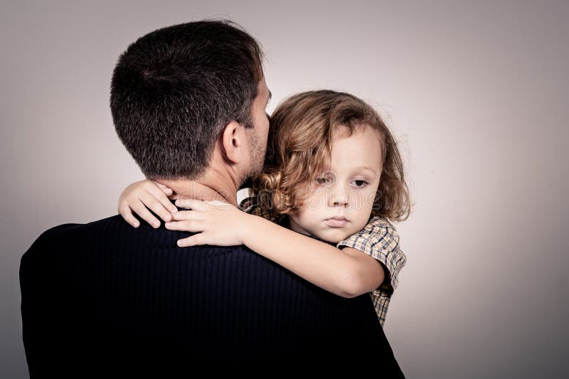 Sad son hugging his dad stock image. Image of offspring - 58303481