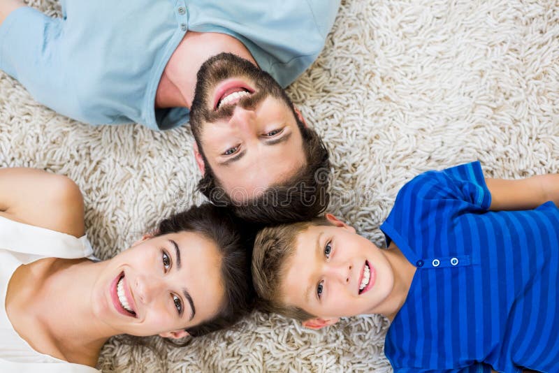 Portrait of Parents and Son Lying on Rug Stock Photo - Image of bonding ...