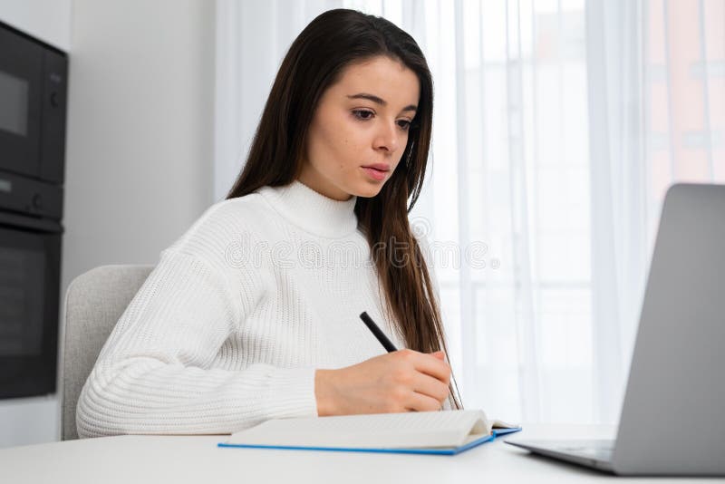 Portrait of a Pensive Young Student Making Notes To the Textbook during ...