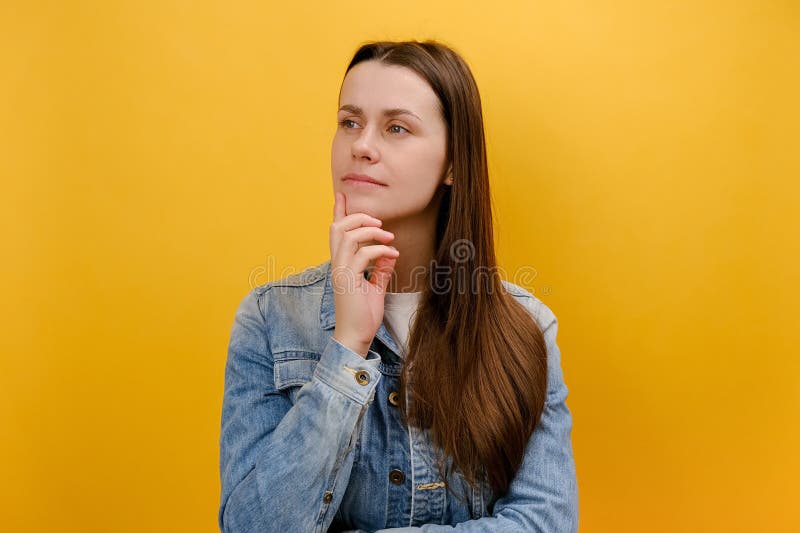 Portrait of Pensive Young Woman Holding Her Chin and Seriously Thinking ...