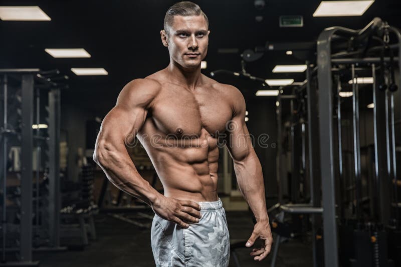 Portrait of a Physically Young Man Holding Weights in Hand Stock Photo ...