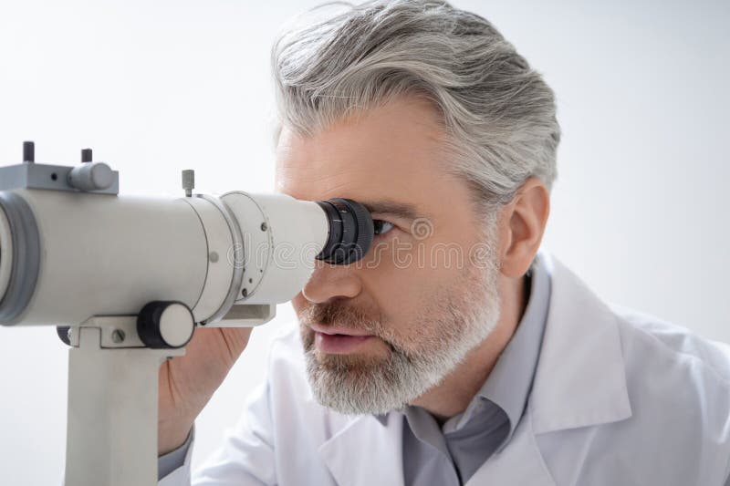 Portrait Picture of a Male Doctor Looking into Microscope and Looking ...