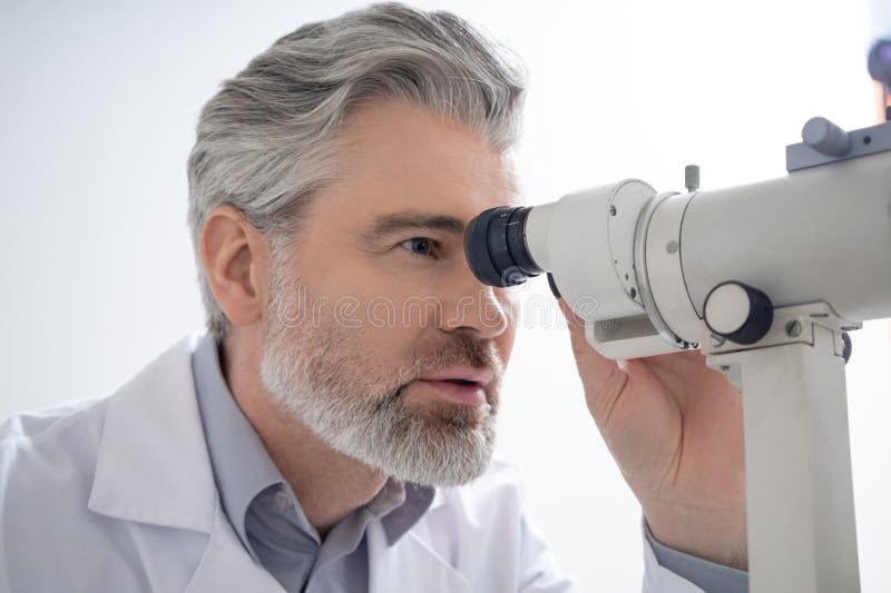 Portrait Picture of a Male Doctor Looking into Microscope and Looking ...