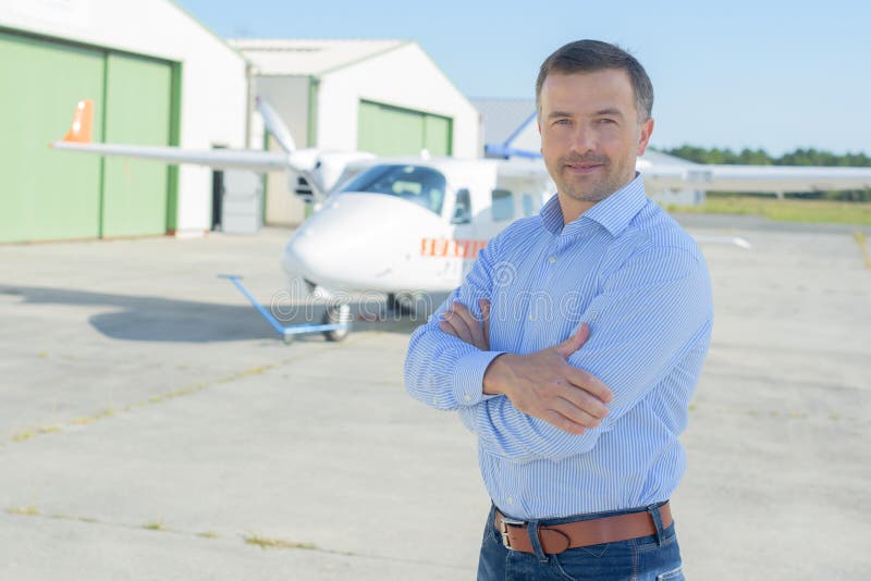 Portrait Pilot beside Plane Stock Image - Image of airport, wealthy ...