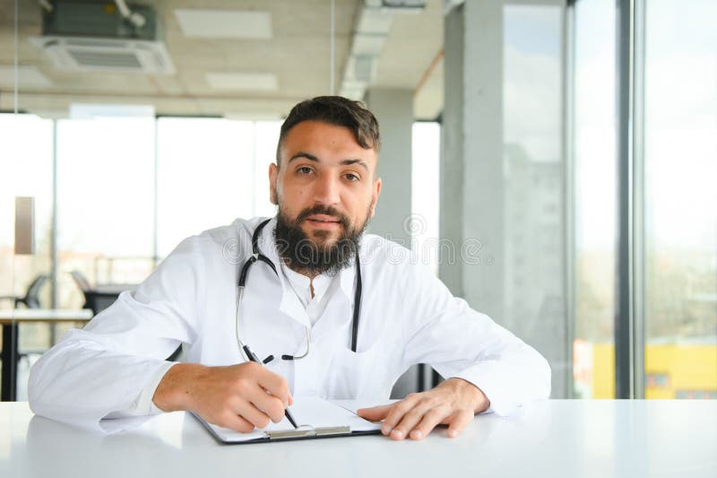 Portrait of Pleasant Young Arabian Doctor in White Coat. Stock Image ...