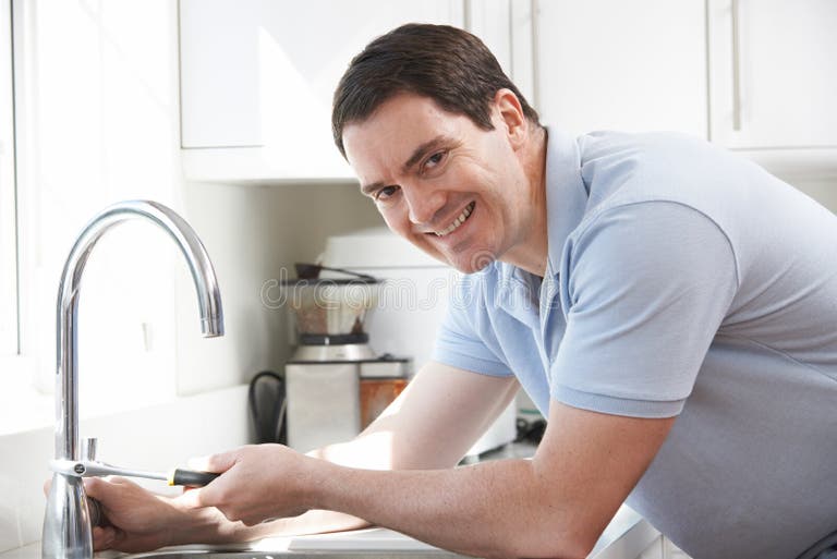 Portrait of Plumber Mending Kitchen Tap Stock Image - Image of smiling ...