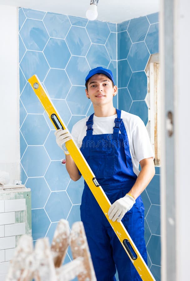 Portrait of Builder Man in Blue Overalls with Building Level in His ...