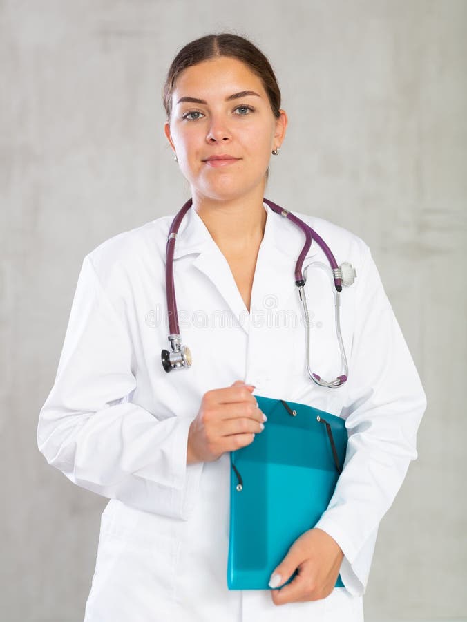 Portrait Of Positive Female Doctor In White Coat With A Stethoscope And