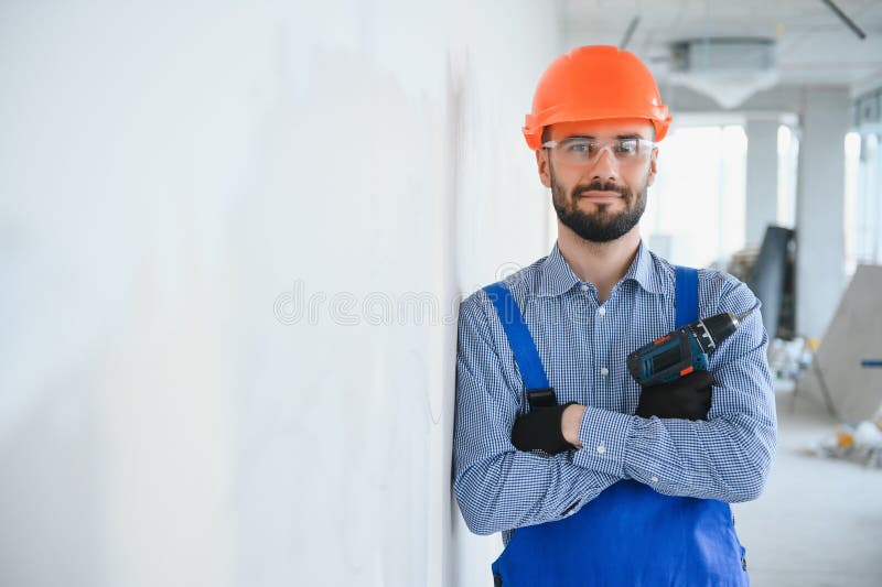 Portrait of Positive, Handsome Young Male Builder in Hard Hat while ...