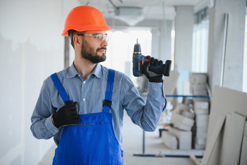Portrait of Positive, Handsome Young Male Builder in Hard Hat while ...