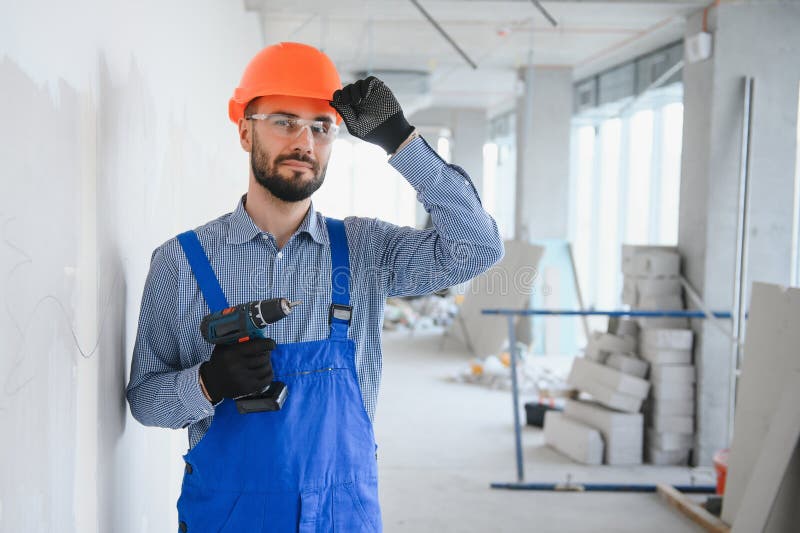 Portrait of Positive, Handsome Young Male Builder in Hard Hat while ...