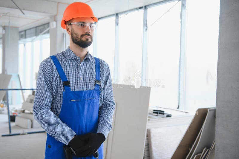 Portrait of Positive, Handsome Young Male Builder in Hard Hat while ...
