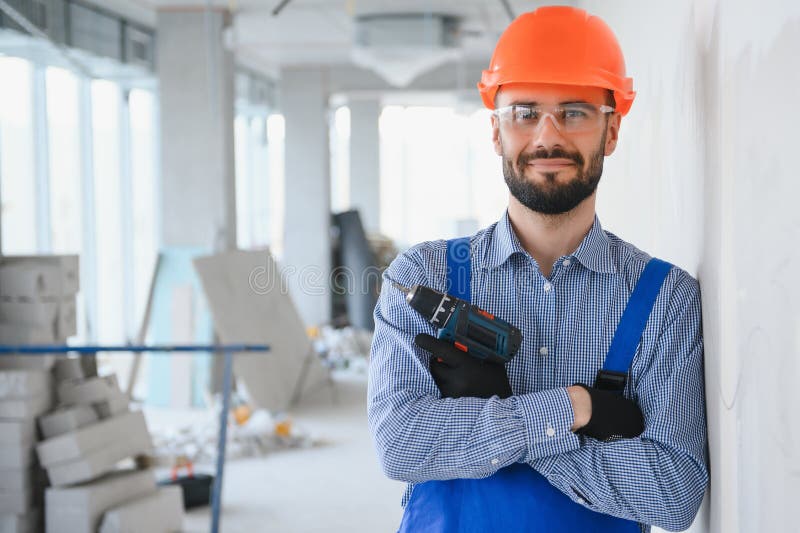 Portrait of Positive, Handsome Young Male Builder in Hard Hat while ...