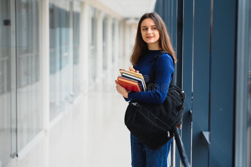 Portrait of a Pretty Female Student with Books and a Backpack in the ...