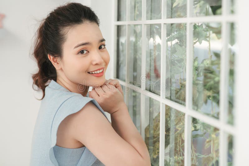 Portrait of Pretty Lady Worker in Office Near Window. Looking at Window ...