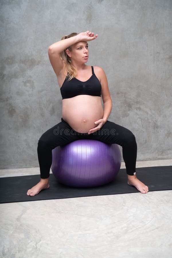 Portrait Of Pretty Pregnant Woman Exercises With Fitball In The Gym