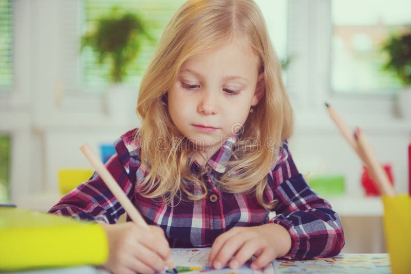 Portrait of Pretty School Girl are Studying at Classroom at the Table ...