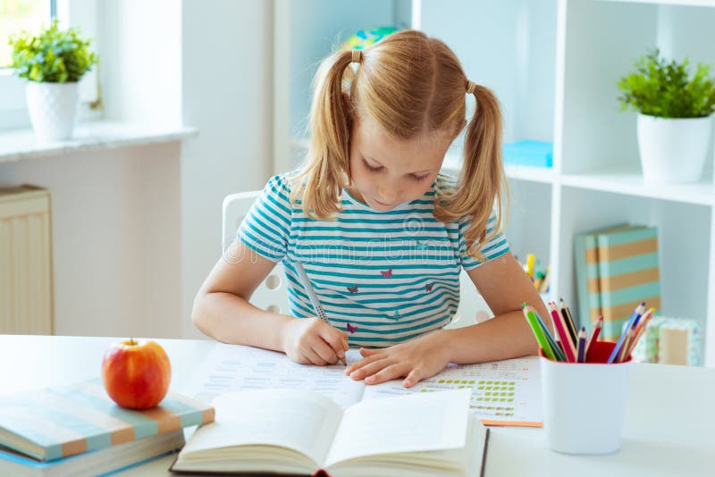 Portrait of Schoolgirl at Classroom Writing at the Table Stock Photo ...