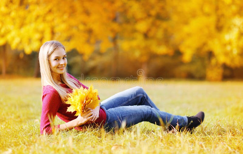 Portrait Pretty Young Woman With Yellow Maple Leafs Outdoors In Stock