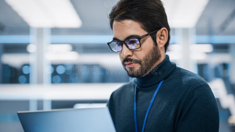 Portrait of a Professional Hispanic Man Using Laptop at Work in ...