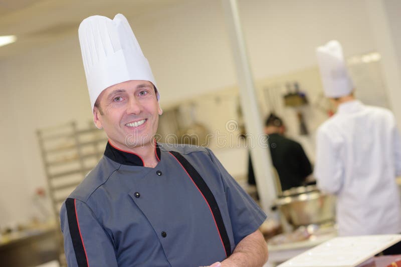 Portrait Professional Male Chef in Busy Kitchen Stock Photo - Image of ...