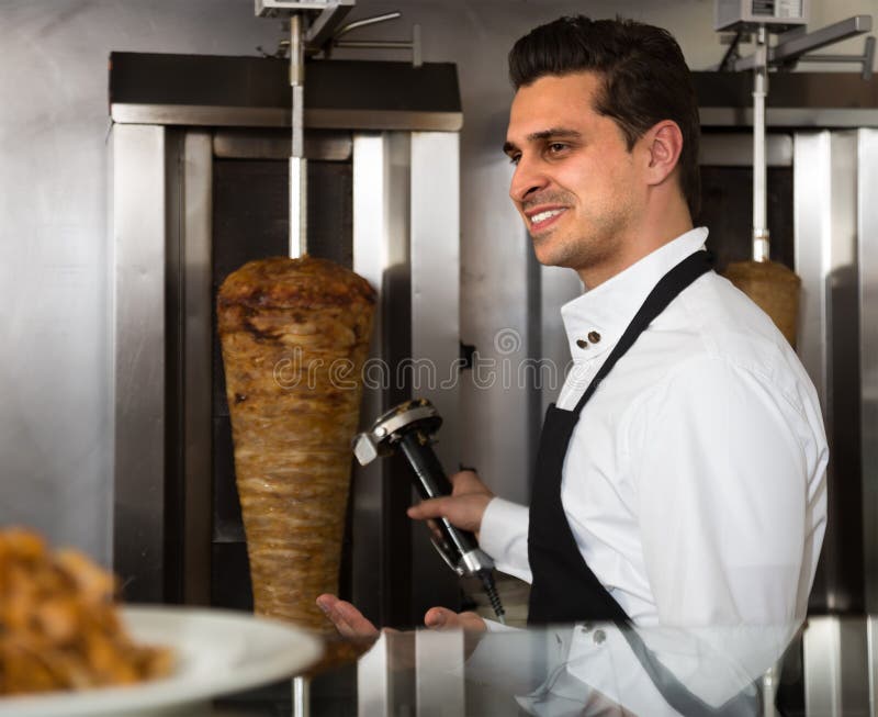 Portrait of Professional Male Chef Cutting Meat for Kebab Stock Photo ...